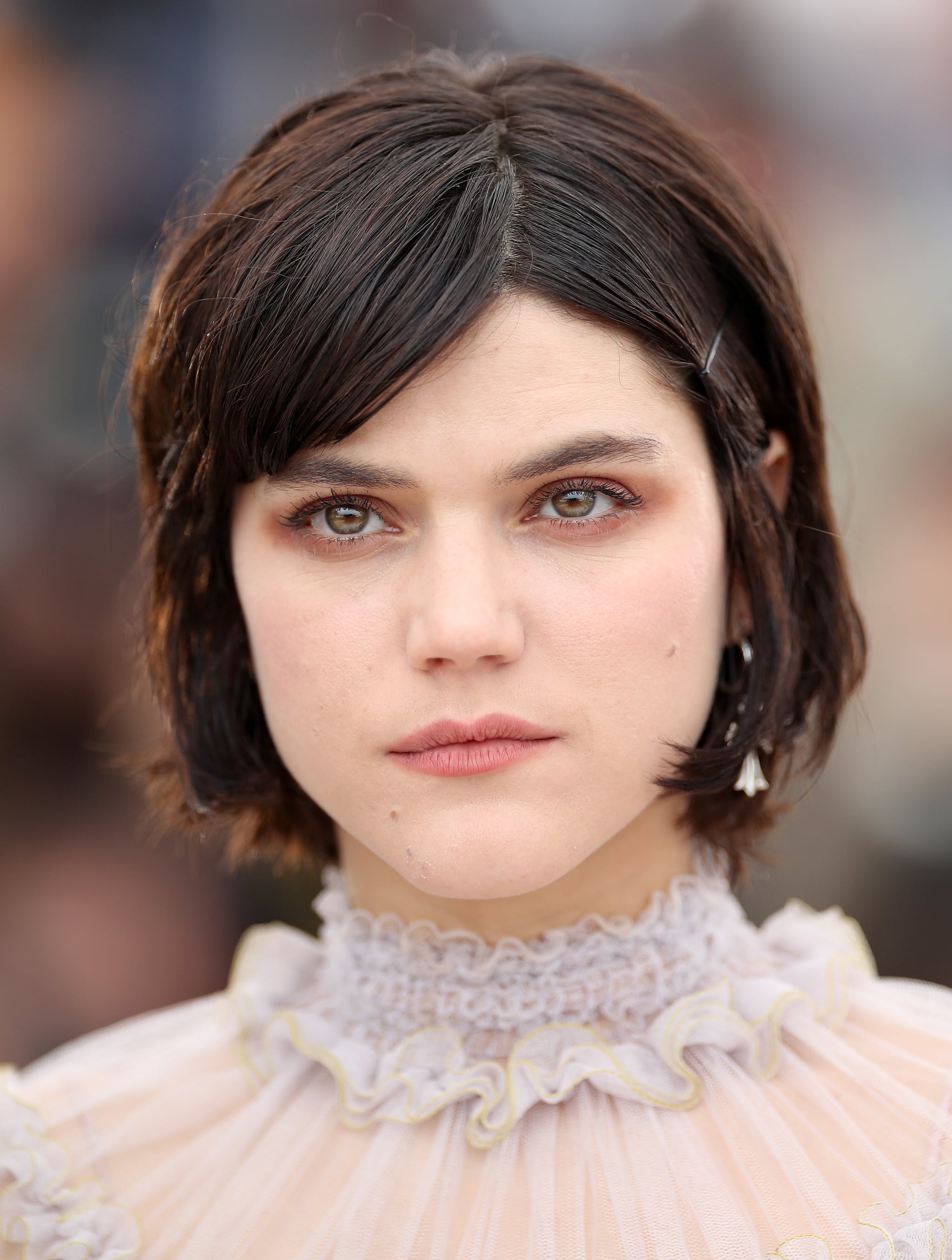 French singer and actress Soko wore a light base with her bob pinned ...